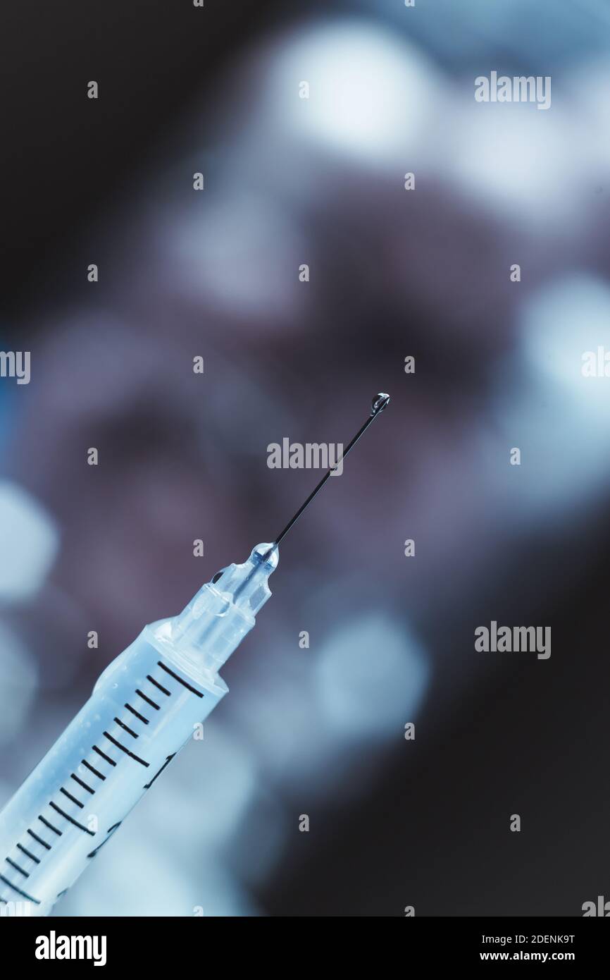 Syringe with needle up and jet and drops of medicine close up Stock ...