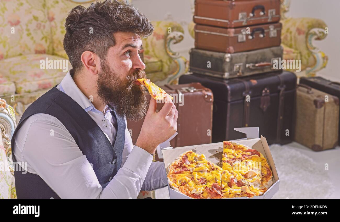 Macho in classic clothes hungry, on surprised face, bites slice of ...