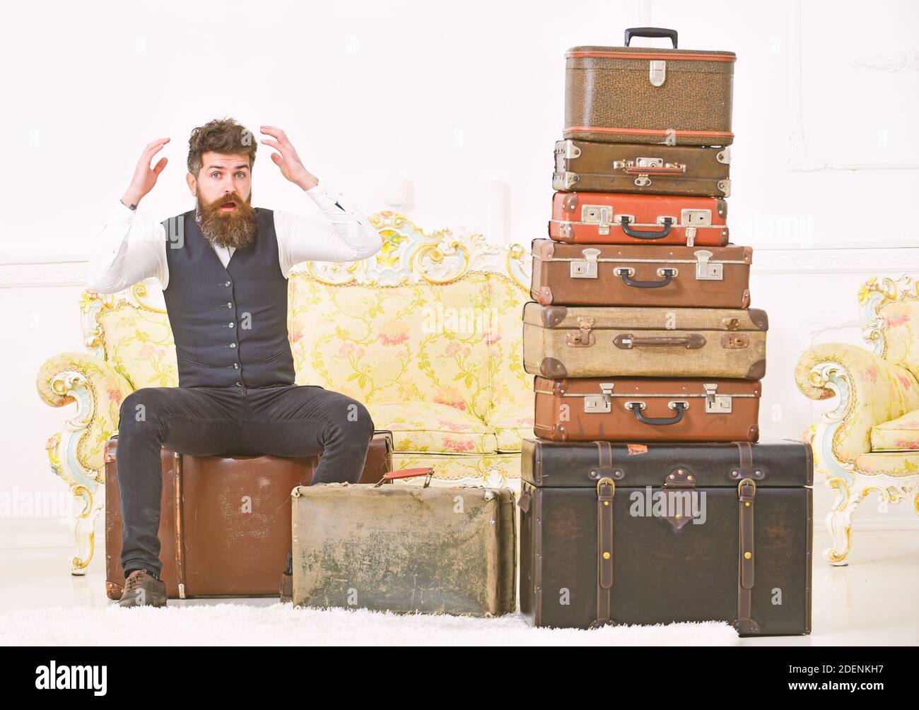 Macho elegant on surprised face sits shocked near pile of vintage ...