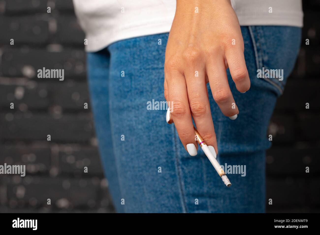 Female hand holding lighted cigarette close up Stock Photo - Alamy