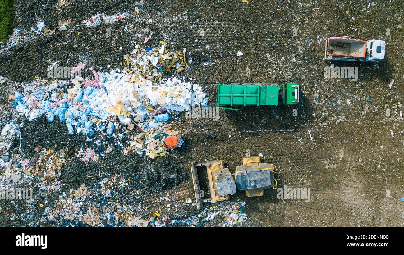 View from above of dump with garbage trucks and tractor. Waste sorting ...
