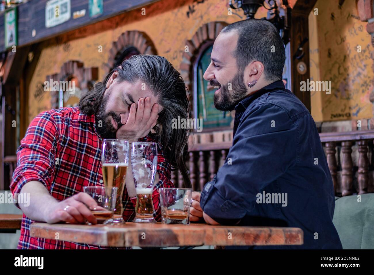 Two male friends drinking whiskey and beer together at the pub. They ...