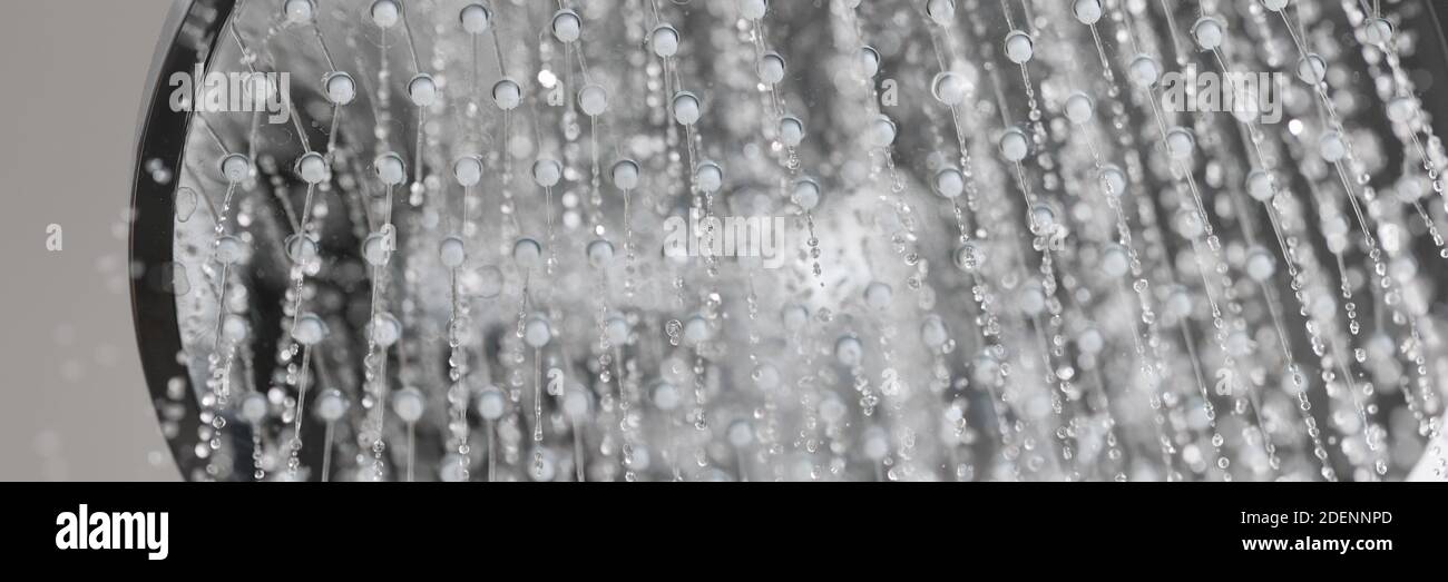 Water is pouring from shower tap closeup Stock Photo - Alamy
