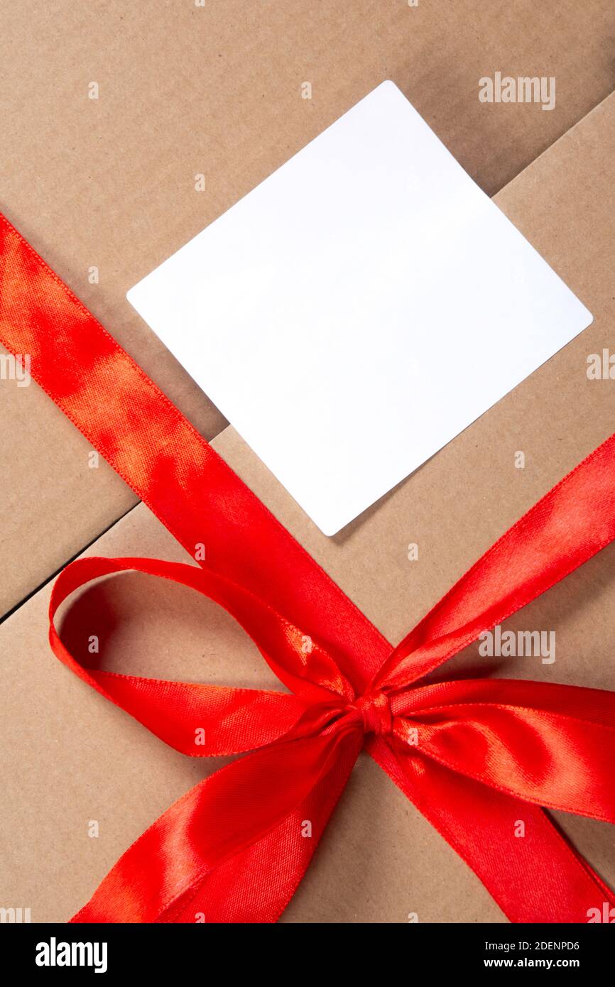 Wrapped kraft square box gift box with red ribbon bow, vintage style ...