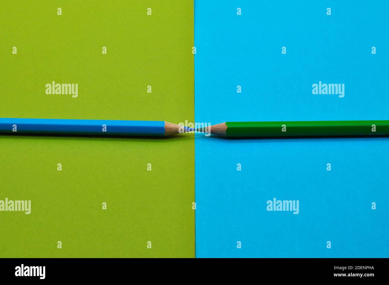 blue and green colored pencils on reverse background, conceptual photo ...