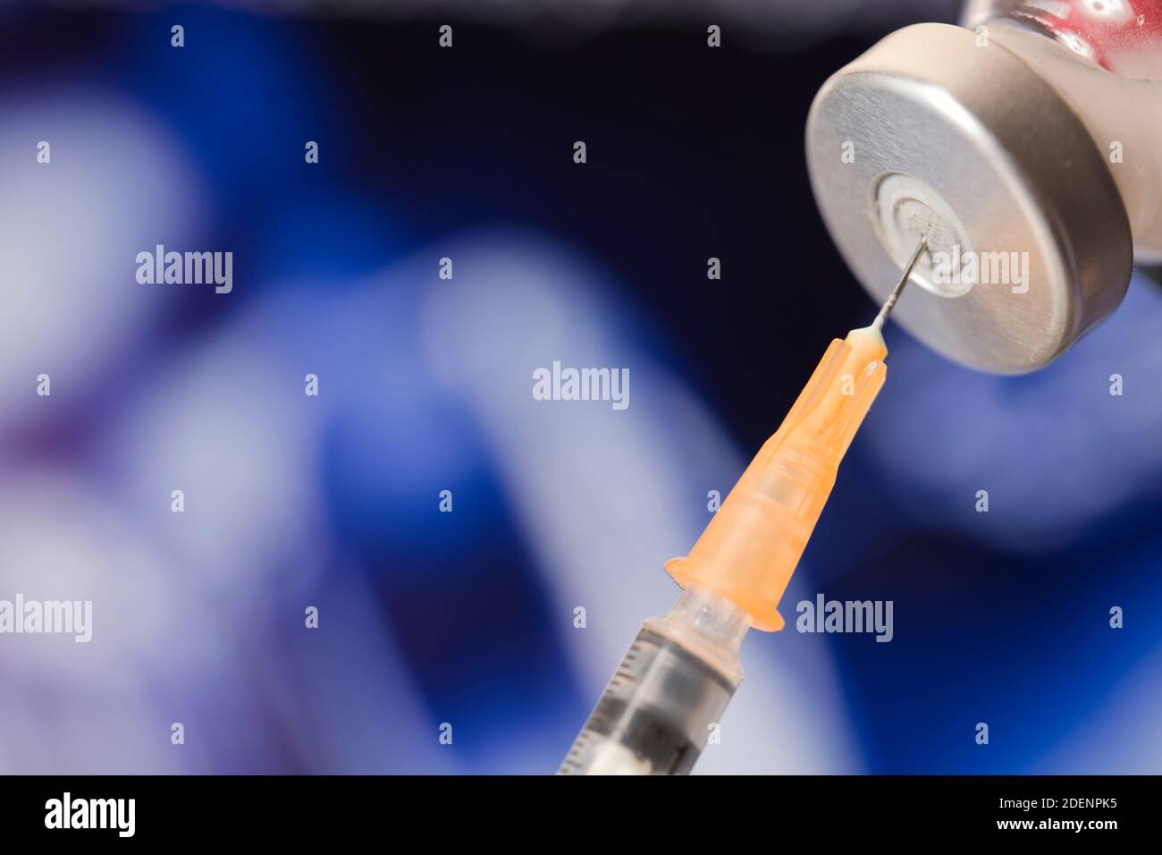 medical syringe cannula with vaccine vial, blue background. macro Stock ...