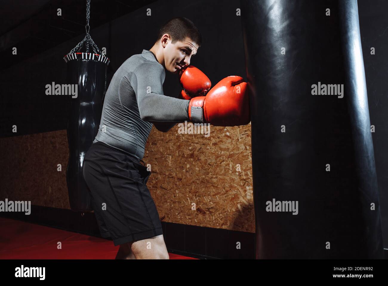 Hand in boxing glove hitting boxing bag hi-res stock photography and ...