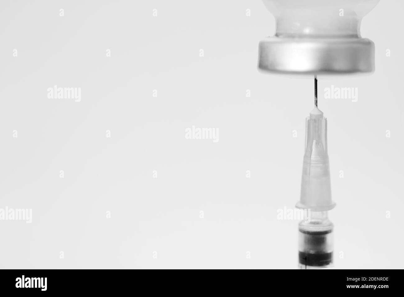 medical syringe cannula with vaccine vial, white background. macro ...
