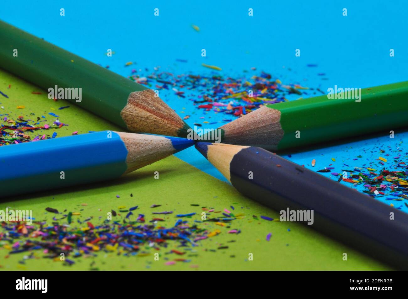 blue and green colored pencils on reverse background, conceptual photo ...