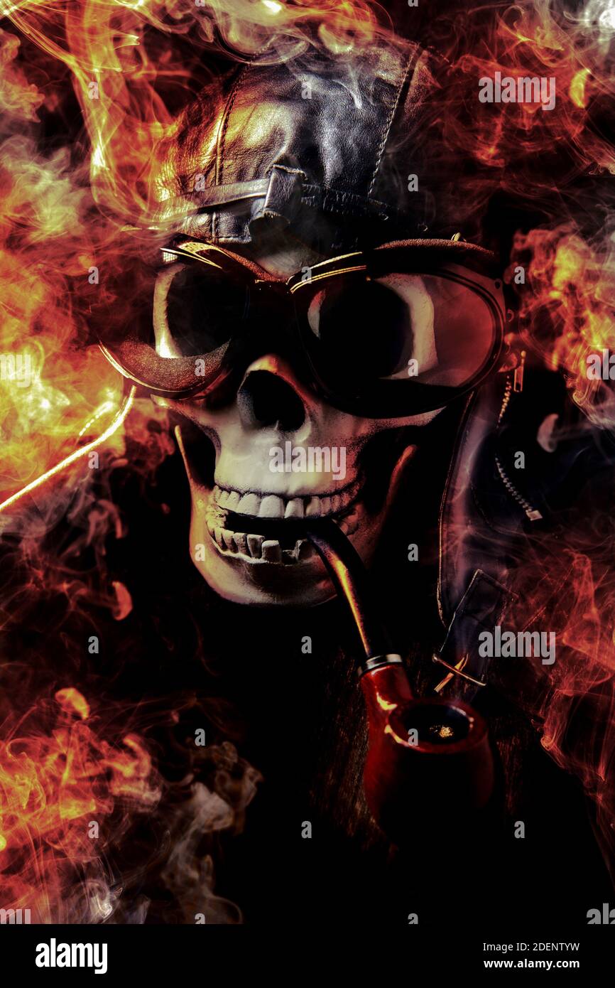 Scary demon Halloween skeleton skull burning in fire Stock Photo - Alamy