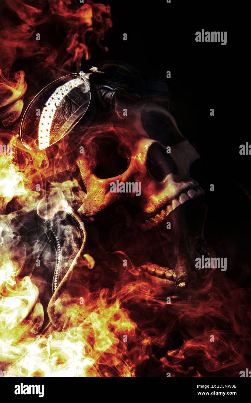 Scary demon Halloween skeleton skull burning in fire Stock Photo - Alamy