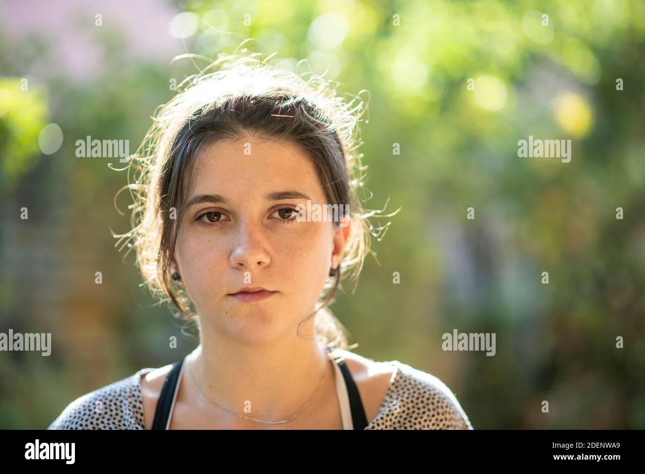 Portrait of a beautiful tired young girl on green background Stock ...