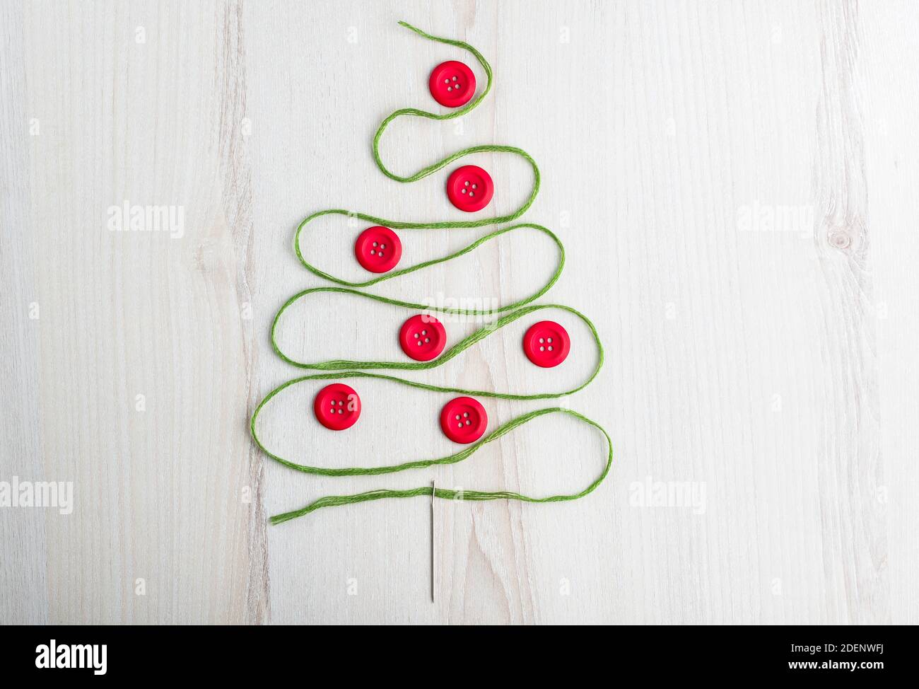 Sewing theme creative flat lay design: Christmas tree made of needle ...