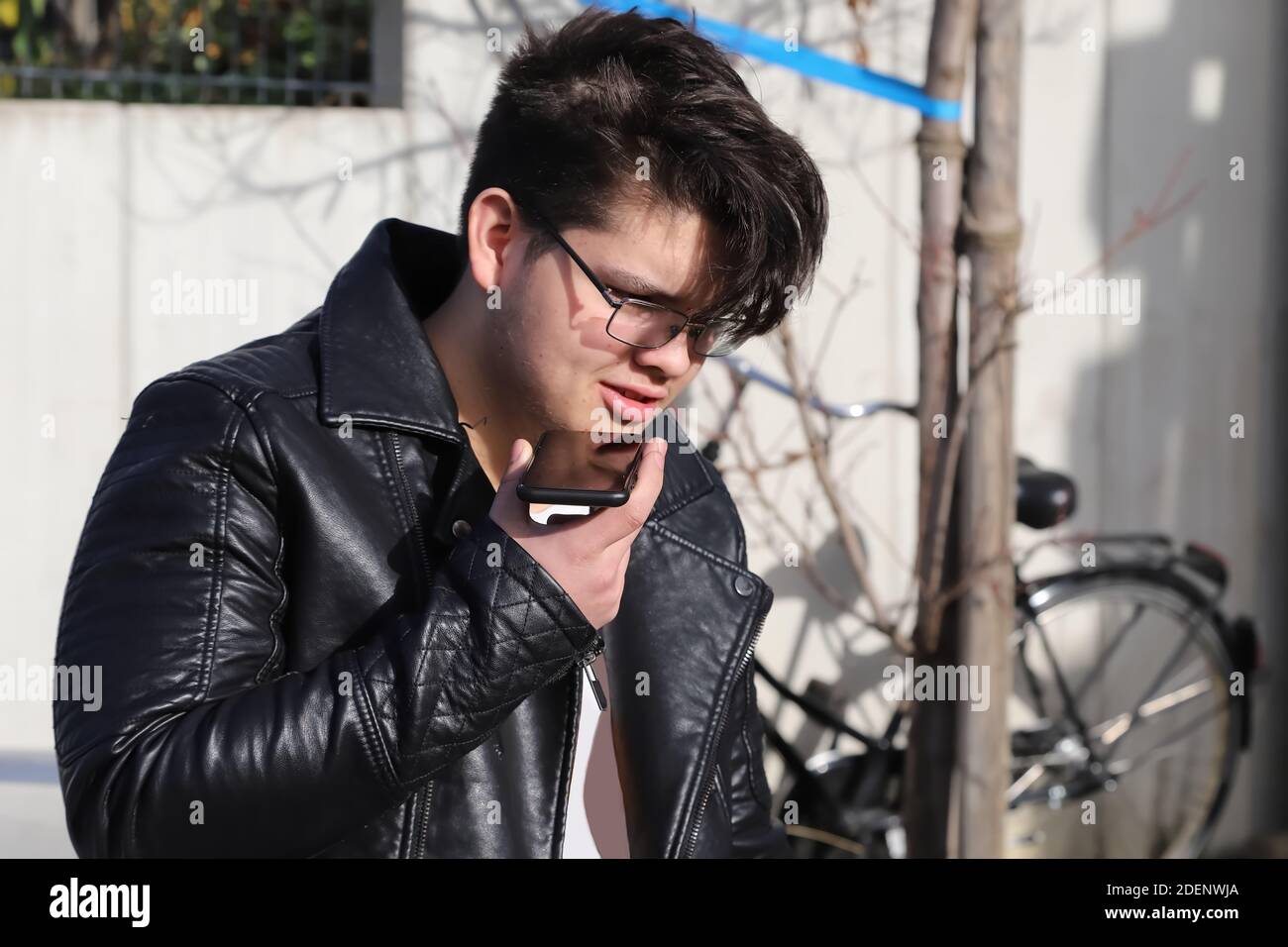 young man talking into phone Stock Photo - Alamy