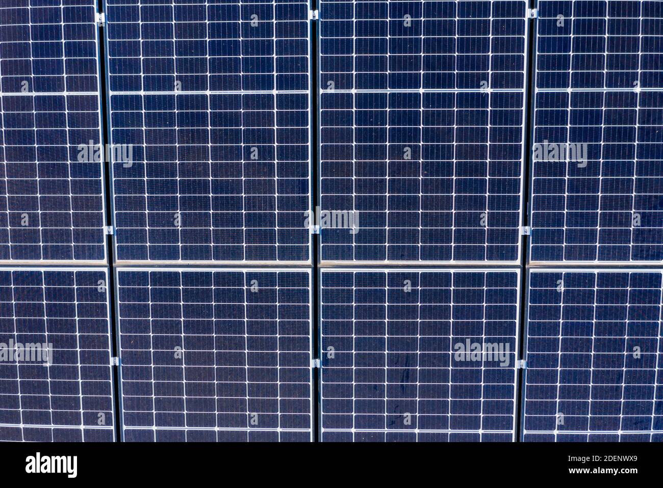 Aerial view of blue solar panels in a square grid pattern on a ...