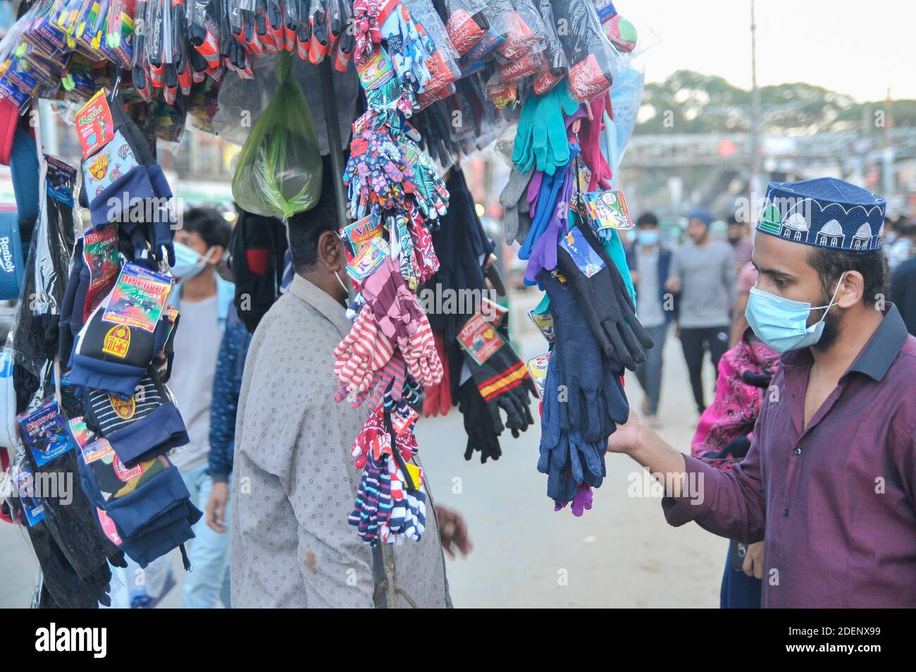 Customers are busy buying winter clothes at street shops in Sylhet ...