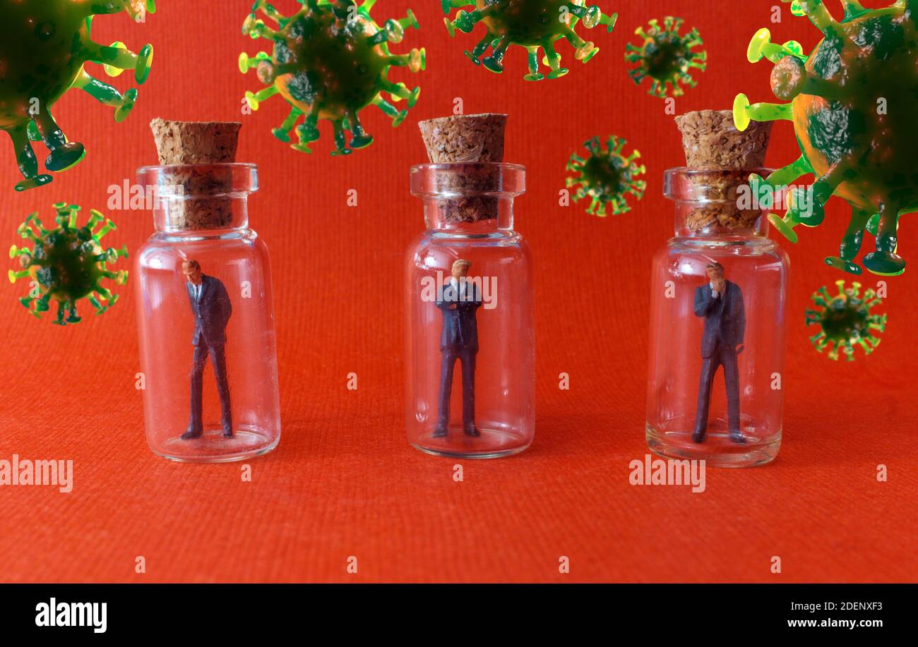 Miniature businessmen practicing social distancing by quarantining in ...