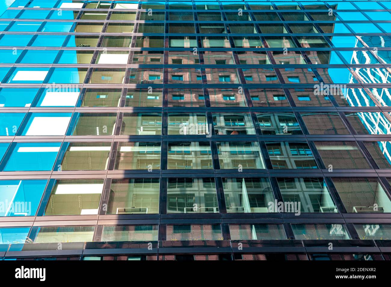 reflections of buildings in the glass wall of a skyscraper Stock Photo ...