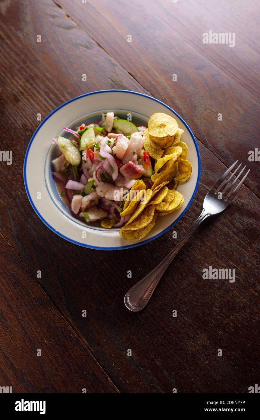 Chilled spicy ceviche with crispy fried plantain chips Stock Photo - Alamy