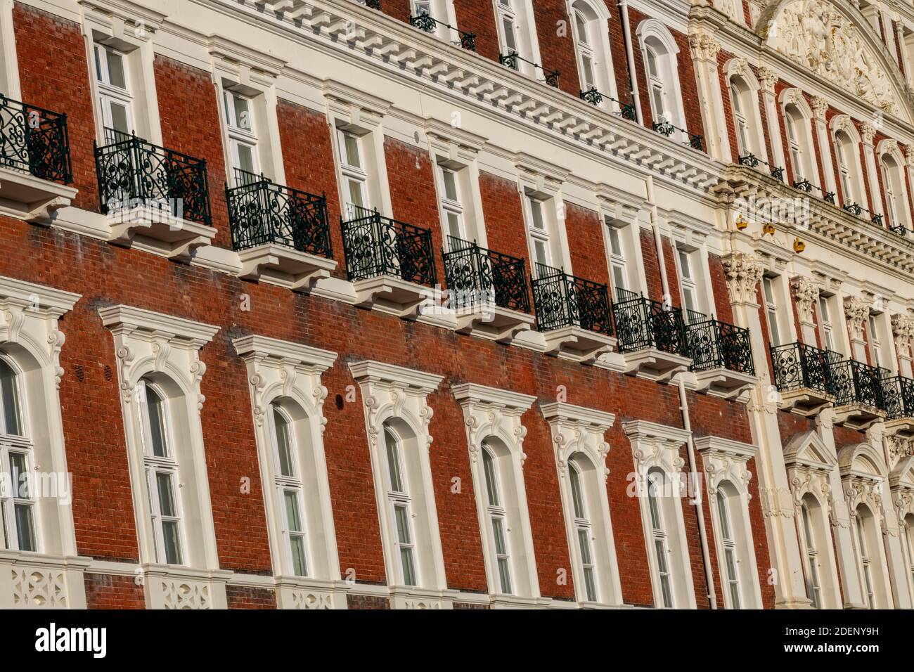 rows of windows in an old victorian ornate office building converted to ...