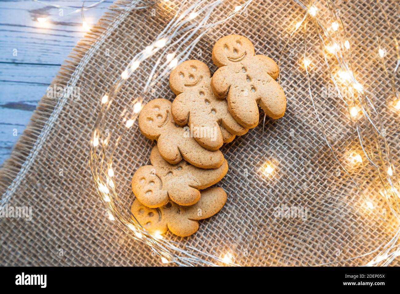 a stack of gingerbread cookies or ginger-man on a white table on brown ...