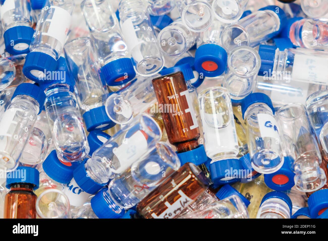 Dirty used chromatographic vials with blue caps. HPLC analysis at ...