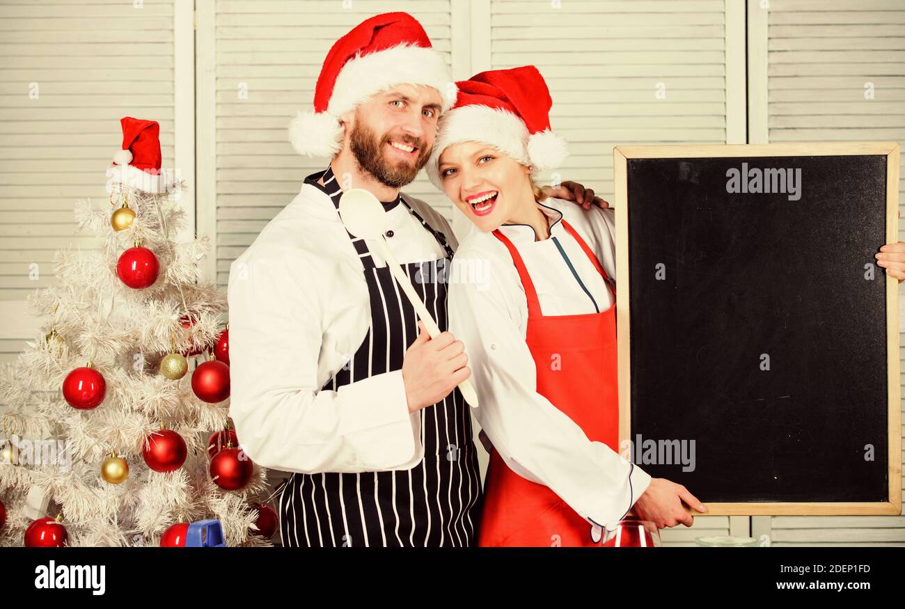 Cooking christmas meal. Menu for our family. Man and woman chef santa ...