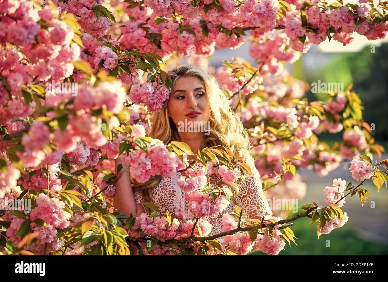 Spring symbol. Girl enjoy sakura in garden. Spring blossom. Happy ...