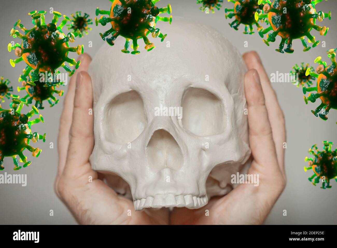 Hands hold worried skull in the air with floating coronavirus ...