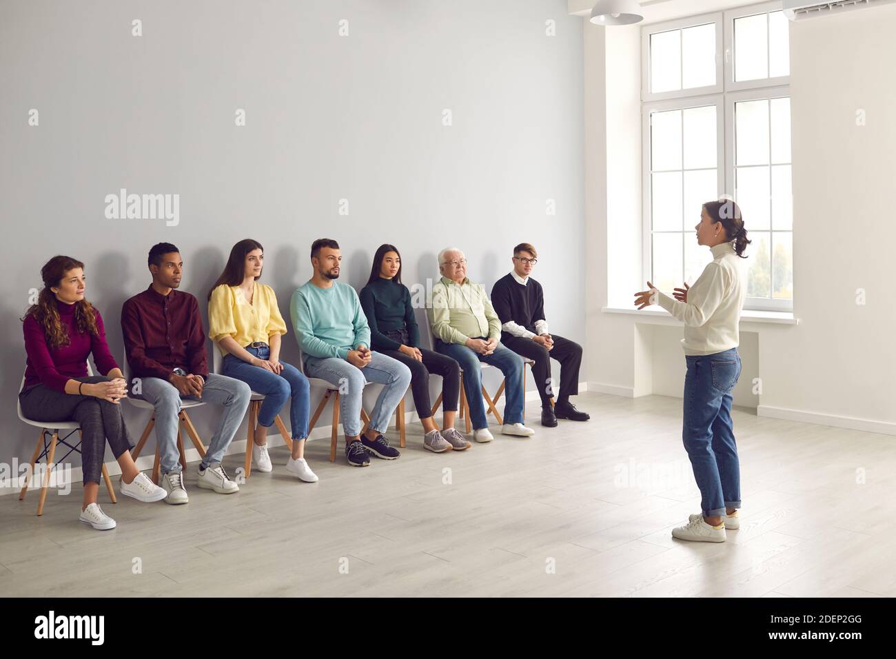 Woman talking to group of people, inviting to club event or drawing ...