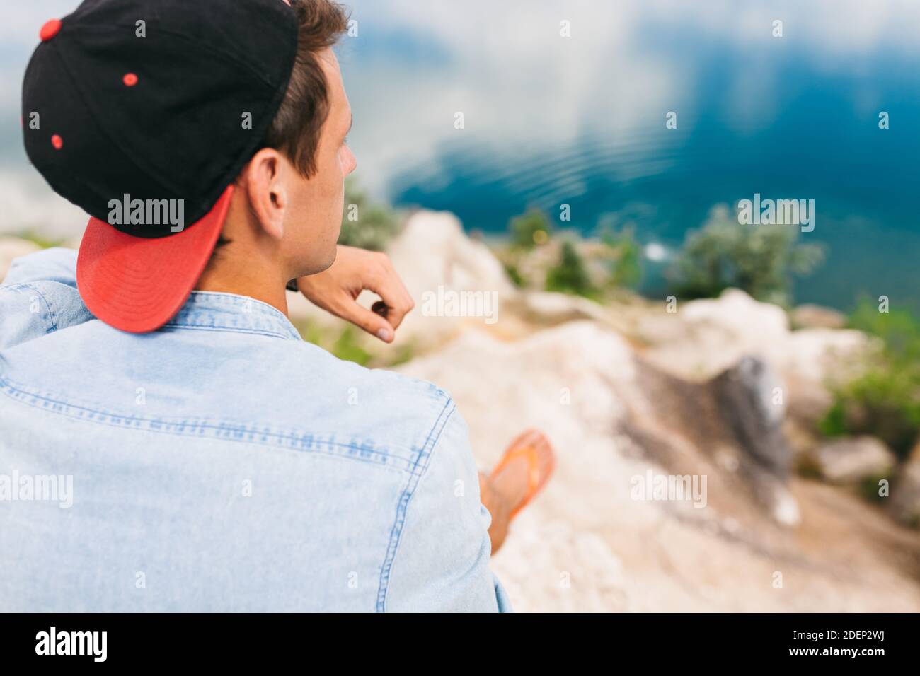 Portrait of a man sitting on a rock, travel around the island, a ...