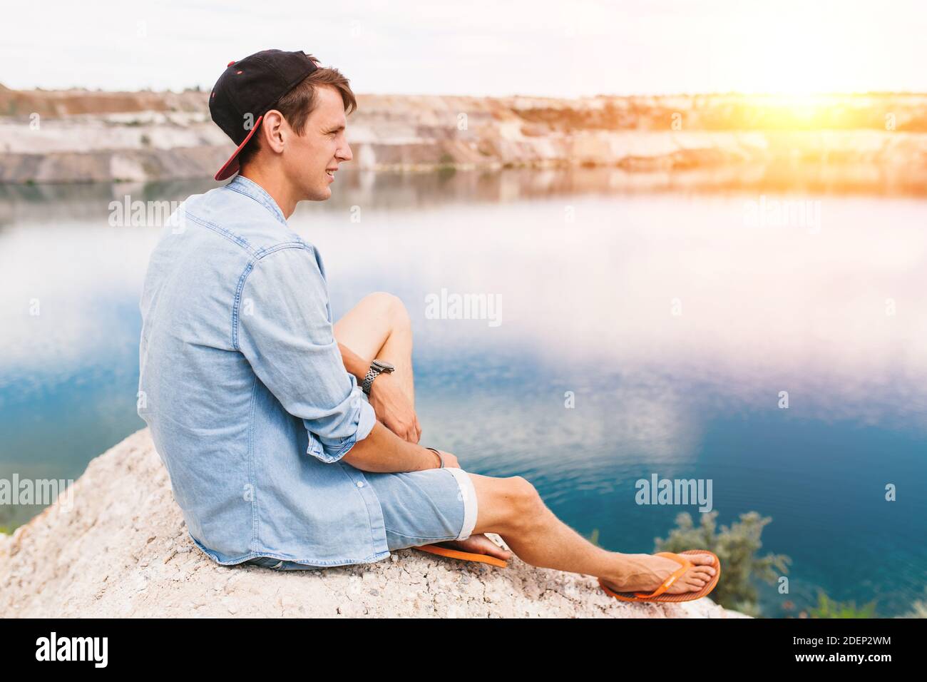 Portrait of a man sitting on a rock, travel around the island, a ...
