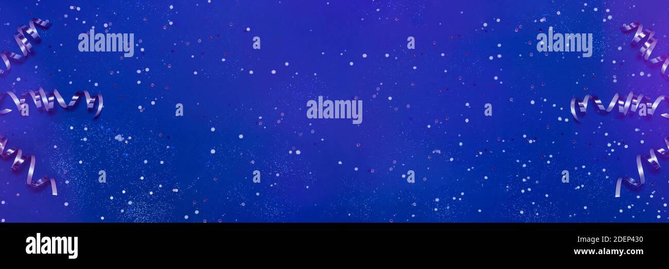 Bright blue banner with sparkles, silver ribbon and confetti of neon ...