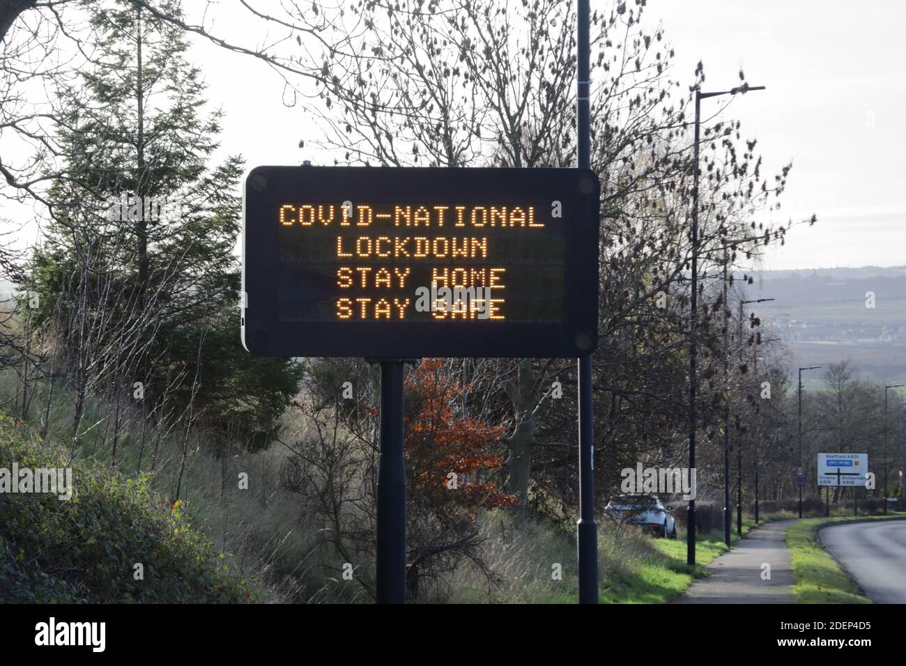 an electronic variable message traffic sign showing coronavirus ...