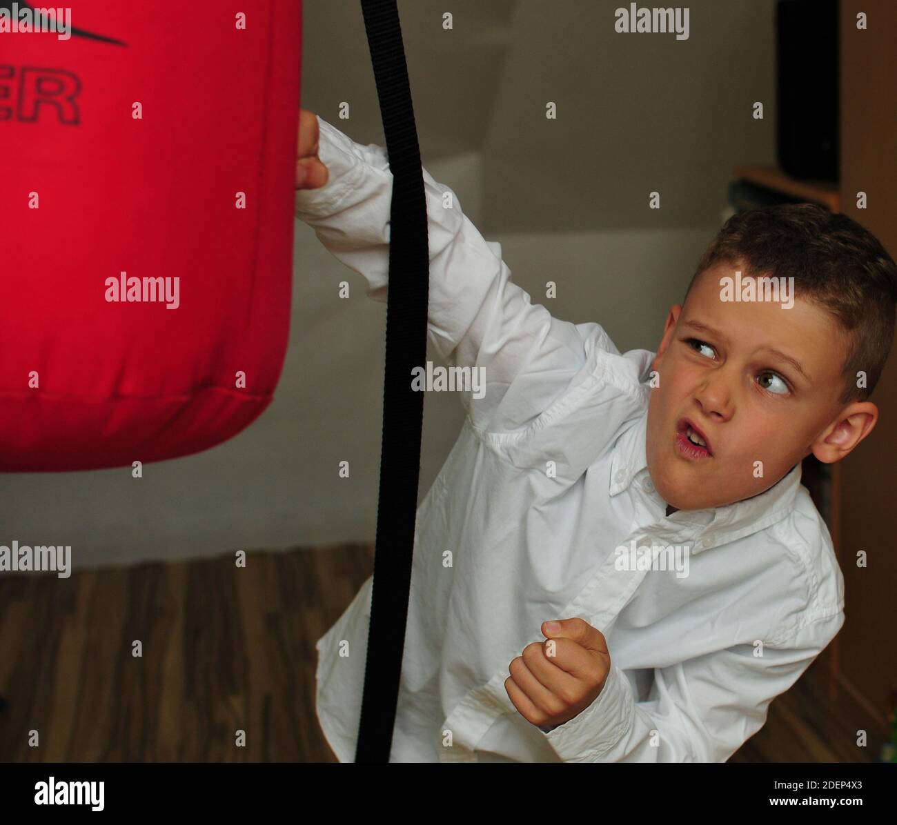 European child from the side looks into the camera with punch Stock ...