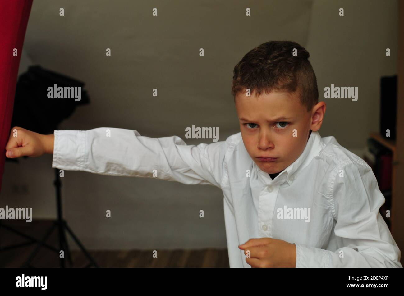 European child from the side looks into the camera with punch Stock ...