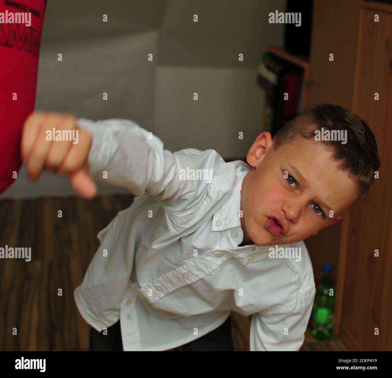 European child from the side looks into the camera with punch Stock ...