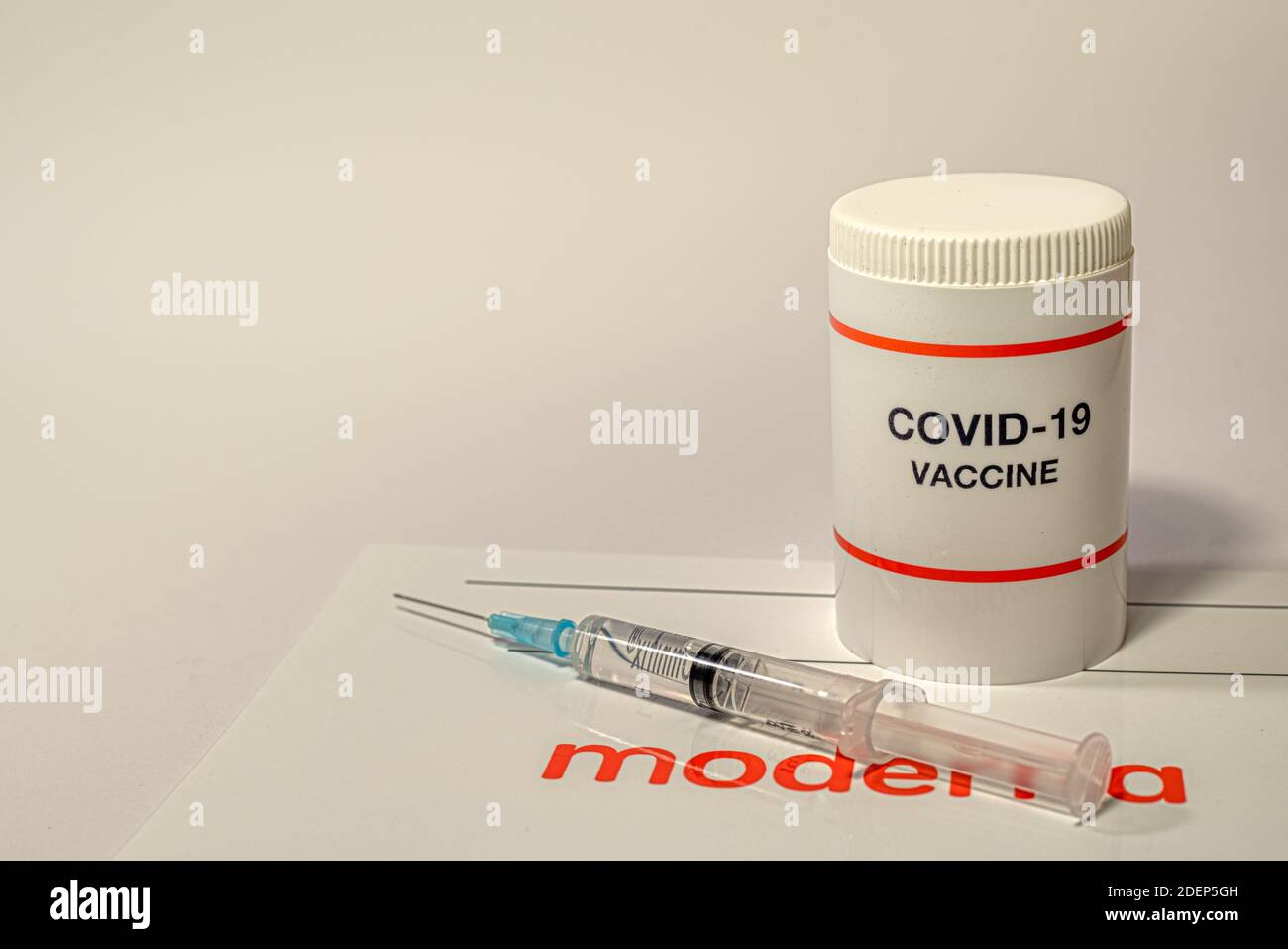 Moderna coronavirus vaccine with a syringe and the company logo on a ...