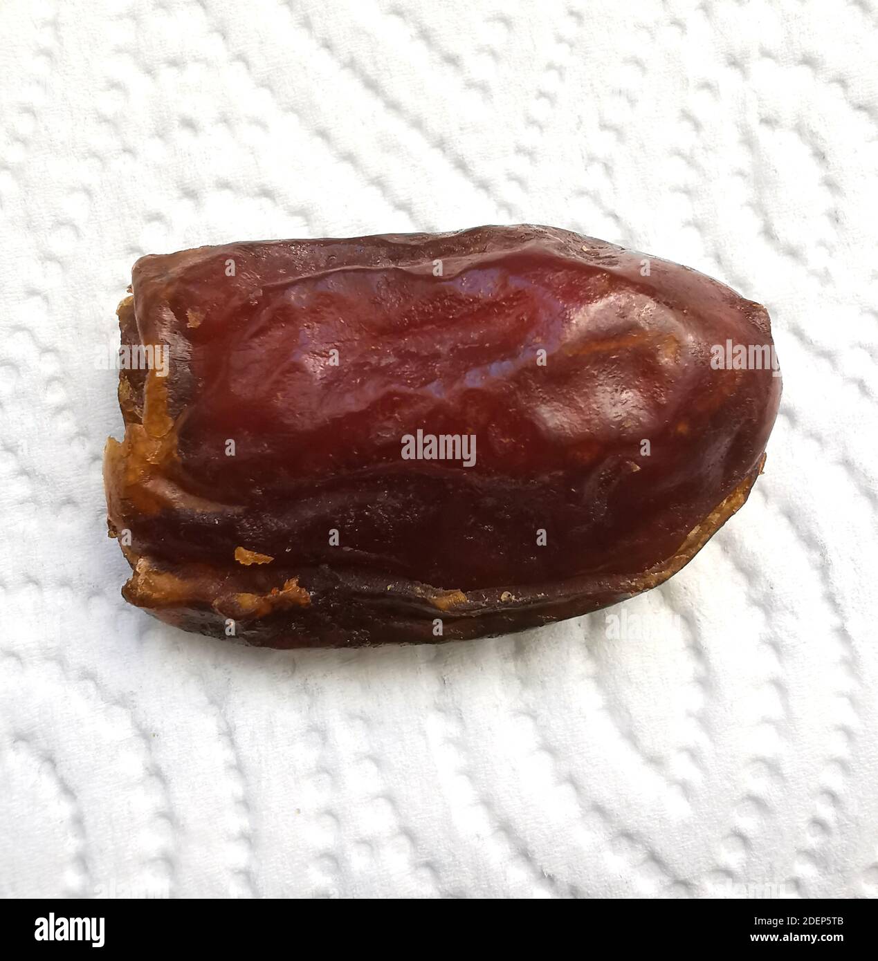 Single dried date fruit closeup on white background Stock Photo - Alamy
