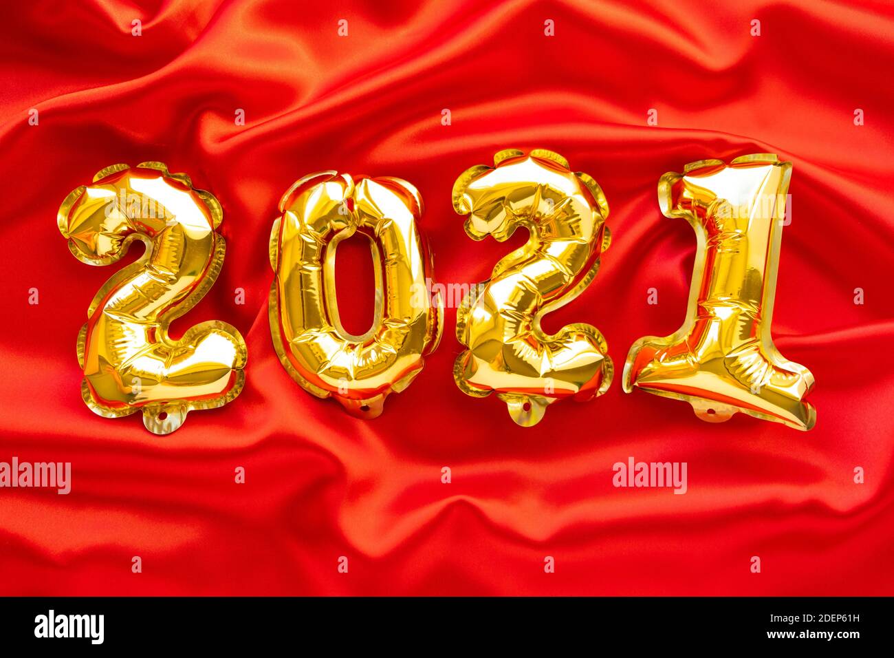 Foil balloons in the form of numbers 2021. New year celebration. Gold ...