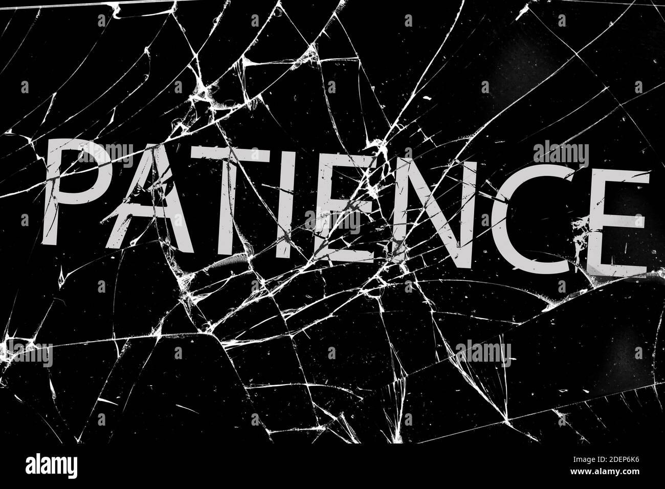 broken glass with cracks with the inscription patience Stock Photo - Alamy