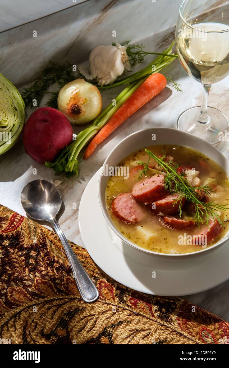 German kielbasa Oktoberfest stew with cabbage potatoes and a glass of ...