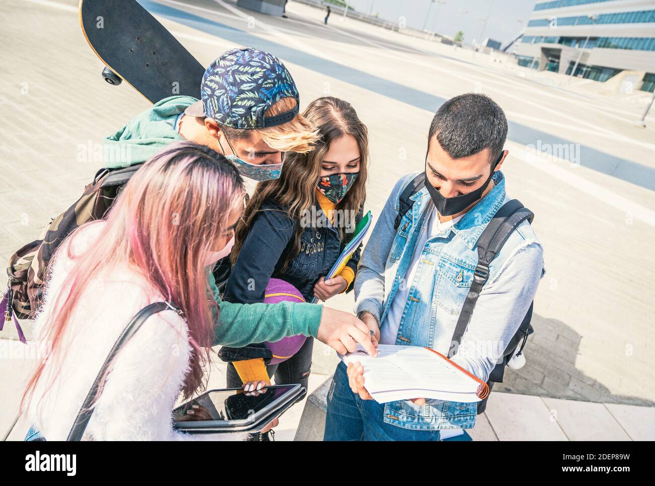 Multiracial students with face mask studying at college campus park in ...