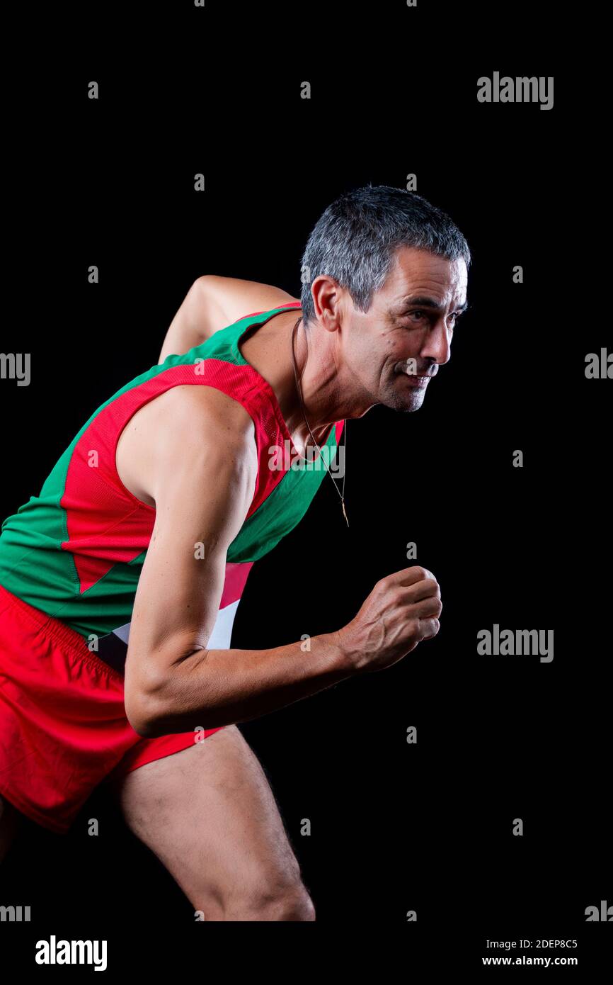 Portuguese runner man of middle age on a black background Stock Photo ...