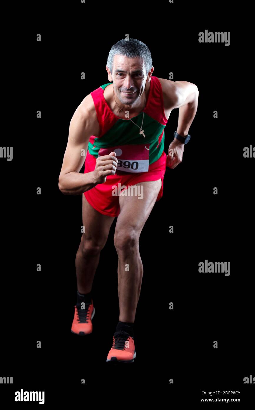 Portuguese runner man of middle age on a black background Stock Photo ...