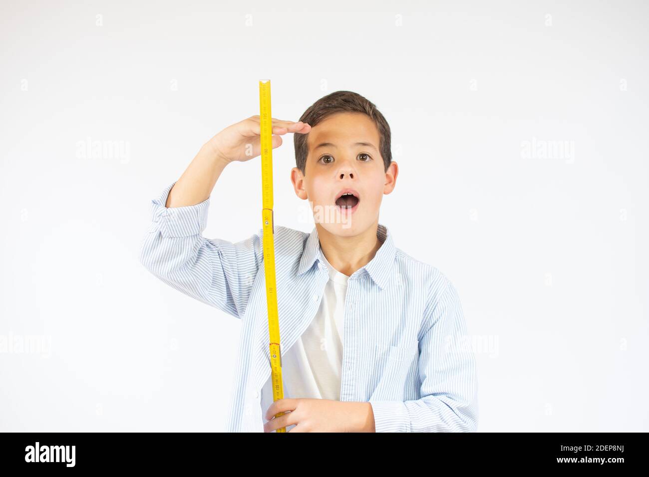 Young beautiful boy measuring his growth in height Stock Photo - Alamy