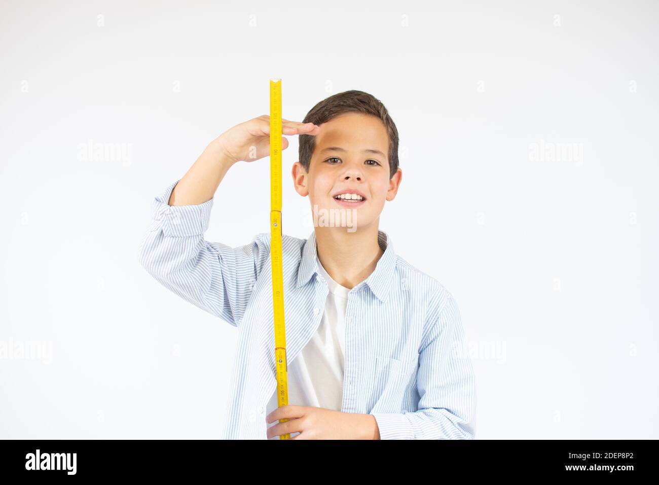 Young beautiful boy measuring his growth in height Stock Photo - Alamy