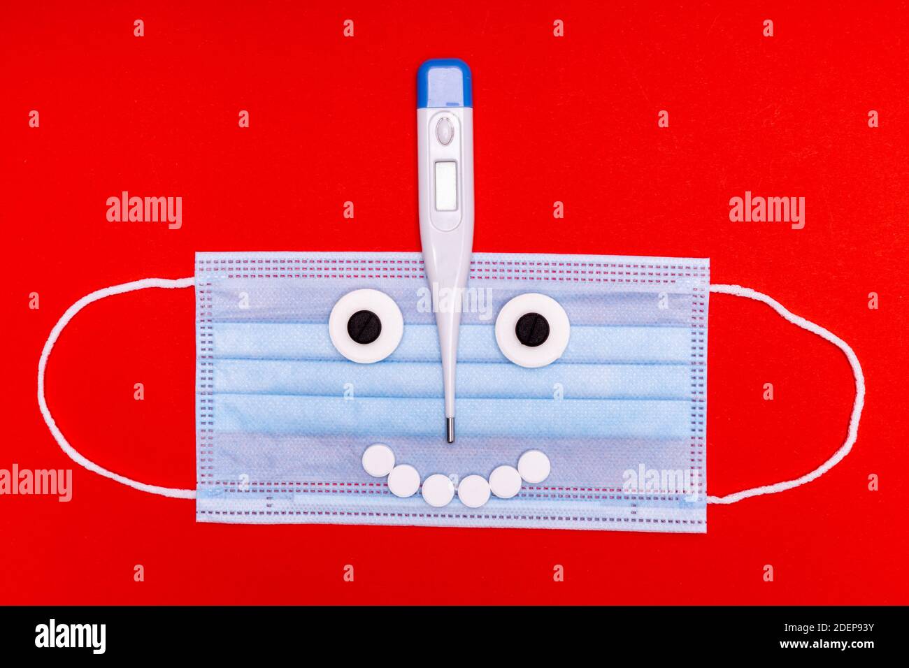 medical mask with a face of tablets and a thermometer Stock Photo - Alamy