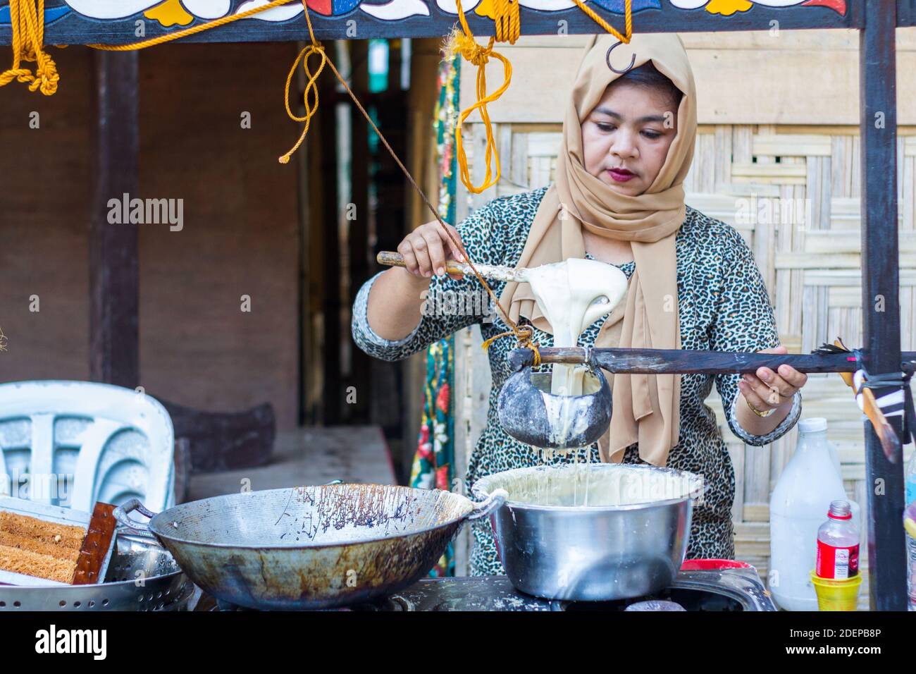 A Mindanao Muslim woman prepares traditional dessert at the Maranao ...
