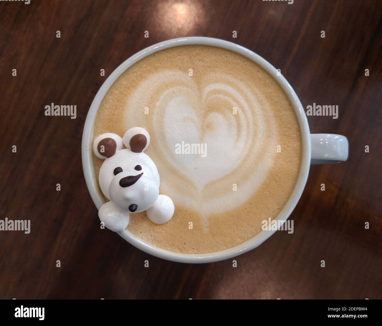 Cappuccino decorated with meringue and chocolate dog figure and a ...
